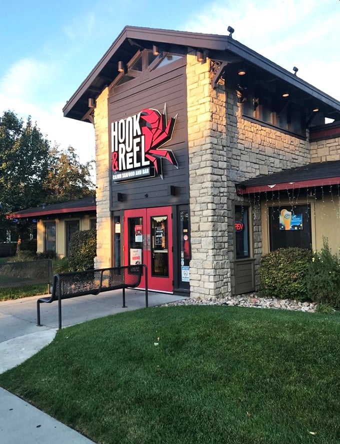 Hook & Reel's bold red crab sign signals serious seafood business ahead. No pretension, just passion for perfect Cajun flavors!