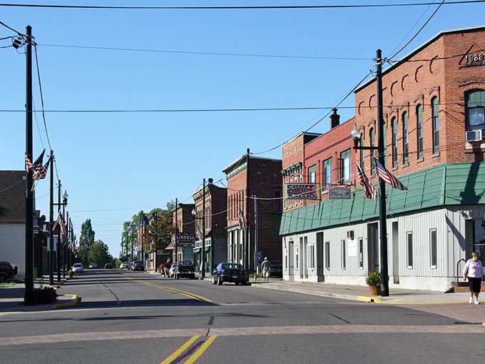 South Haven's iconic red lighthouse stands defiant against winter's icy grip, a scene so Michigan it practically shouts "you betcha!"