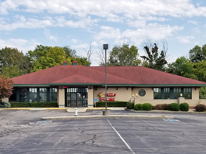 Pizza King's unassuming exterior hides a wonderland where tiny trains deliver drinks straight to your table!