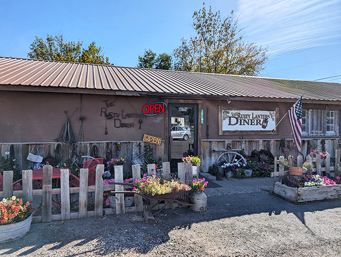 The Rusty Lantern's weathered exterior and picket fence garden display the kind of authentic country charm you can't manufacture or franchise.