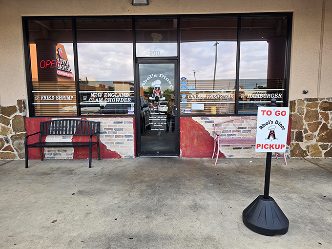 The unassuming entrance to Abel's Diner features a "TO GO PICKUP" sign - a lifesaver when you need those breakfast tacos on the run!