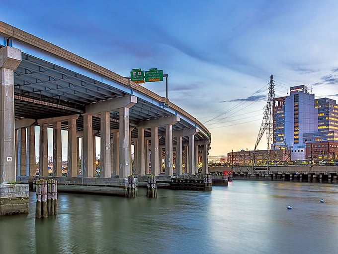 Bridgeport's impressive bridge spans the harbor at sunset, where infrastructure and natural beauty create a stunning urban vista.