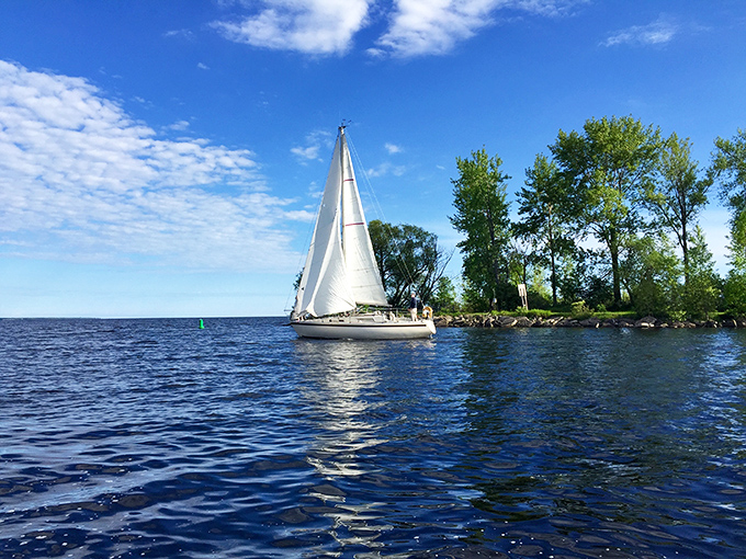 Sailboats dance across Escanaba's harbor waters, where Lake Michigan serves up postcard moments with every gentle wave.