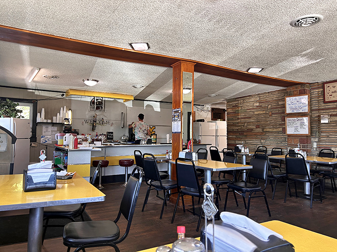 Yellow tables, simple chairs, and a kitchen that knows its way around a burger patty. Hilltop's interior speaks the universal language of comfort.