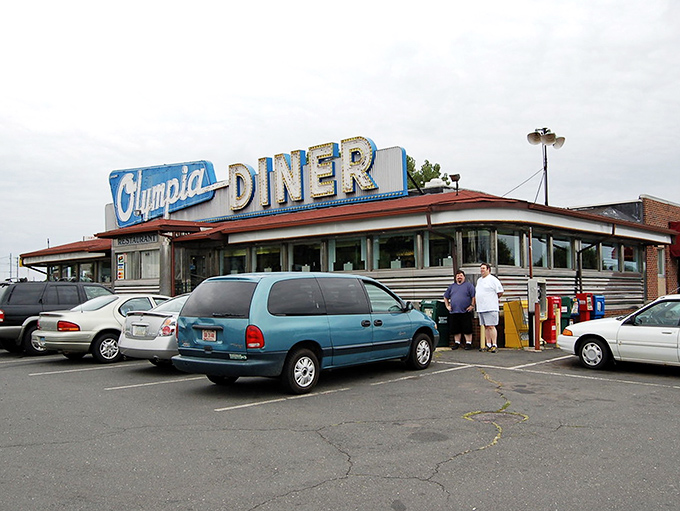 Olympia Diner with parked cars: "The curved roof and iconic sign have welcomed hungry travelers for generations&mdash;a roadside cathedral to the religion of good eating."