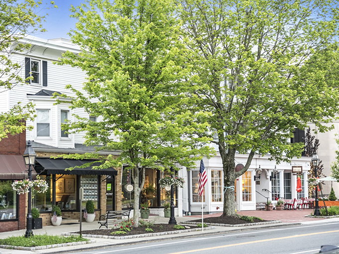 American flags line Ridgefield's main street, where motorcyclists and locals share the road in small-town harmony.