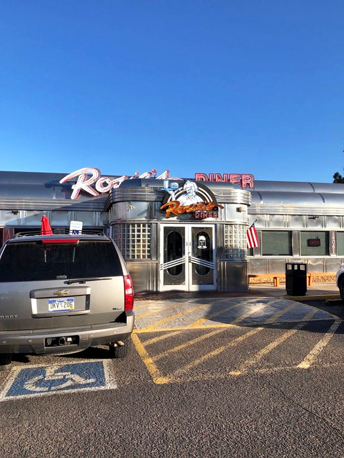 The neon "DINER" sign glows with the promise of fluffy pancakes and coffee refills that never end.