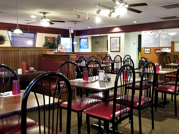 Take a seat in a cozy booth at Silver Spoon Restaurant, where warm lighting and classic charm make you feel home.