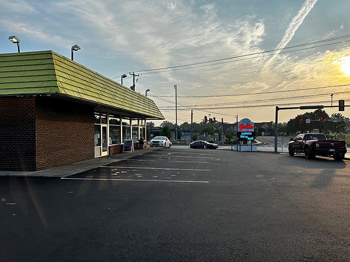 Morning light hits Yum Yum's distinctive building, where generations have started their day with perfect glazed donuts and coffee.