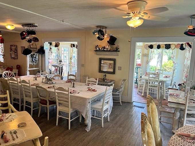 Teapots and hats dangle from the ceiling like whimsical chandeliers, while white lace tablecloths and mismatched chairs create the perfect setting for morning revelations.