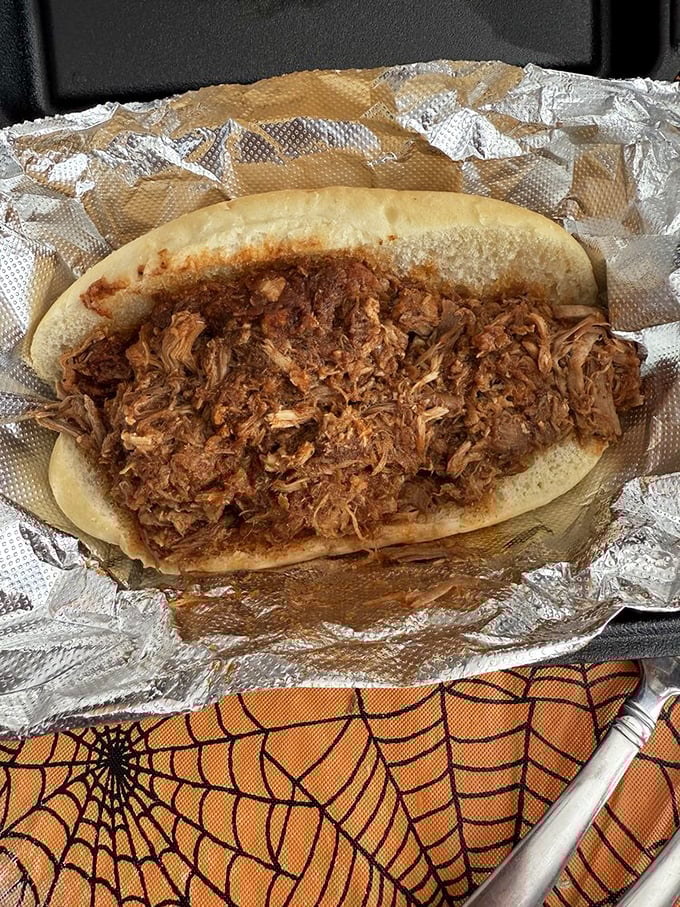 Behold, the pulled pork sandwich in its natural habitat. It's like a meaty hug between two buns.