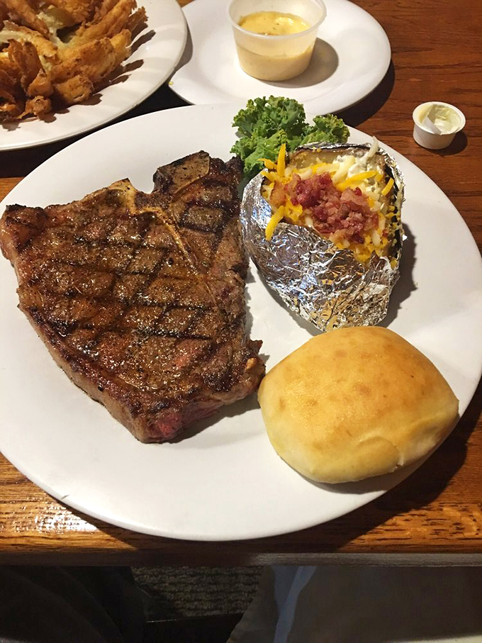 This T-bone steak and loaded baked potato combo isn't just dinner – it's what cowboys dream about after a long day on the range.