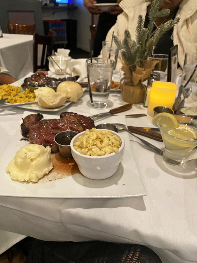 The holy trinity of comfort: perfectly seared steak, cloud-like mashed potatoes, and mac & cheese that would make your grandmother question her recipe.
