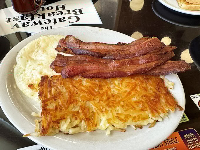 Bacon cooked to that perfect point between chewy and crisp, alongside eggs and hash browns that have clearly found their purpose in life.