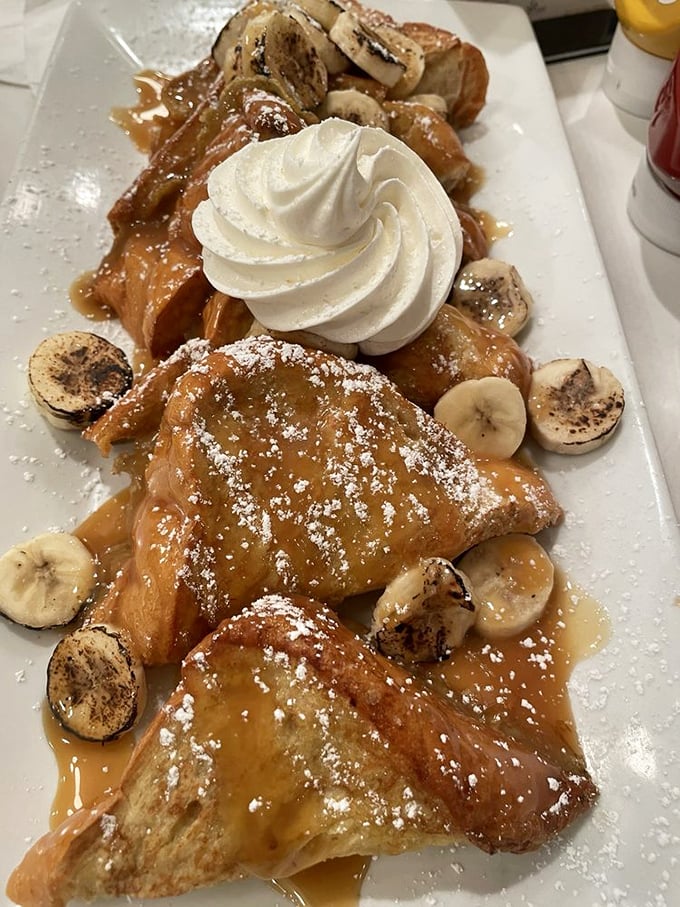 Bananas and French toast have a passionate love affair on this plate, complete with caramel drizzle and a powdered sugar snowfall.