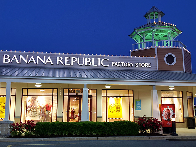 Banana Republic after dark&mdash;when the lighthouse cupola glows and sale signs beckon like sirens to weary shoppers seeking "just one more store."