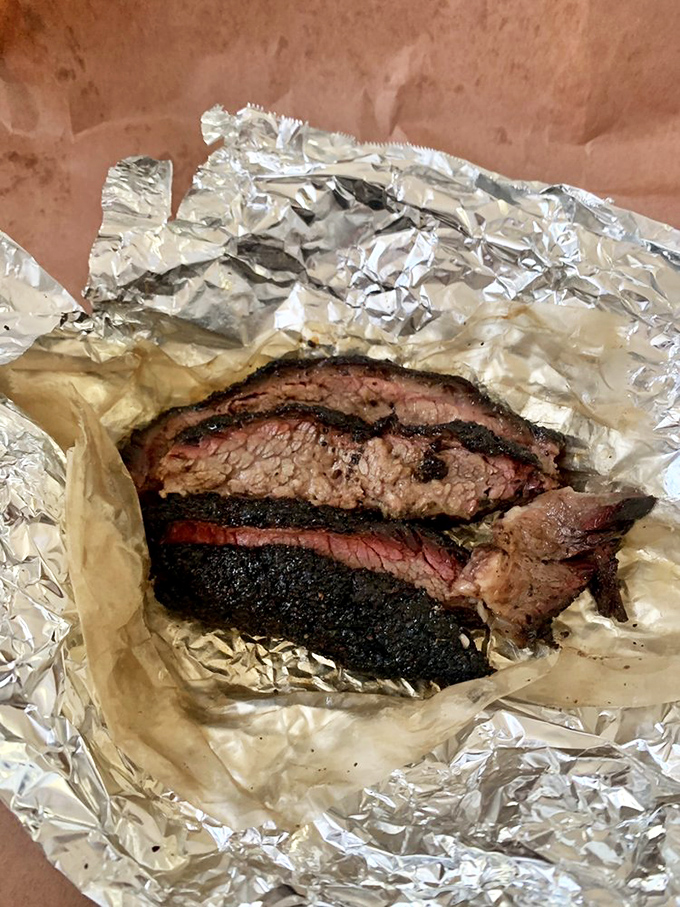 Each slice tells a story of patience and expertise&mdash;the rendered fat glistening like jewels against the mahogany bark of perfectly smoked beef.