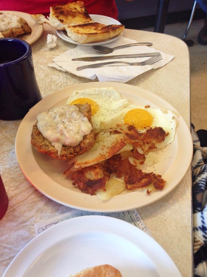 The perfect breakfast trinity: crispy bacon, golden hash browns, and country fried steak wearing its gravy coat with pride. Simplicity at its most satisfying.
