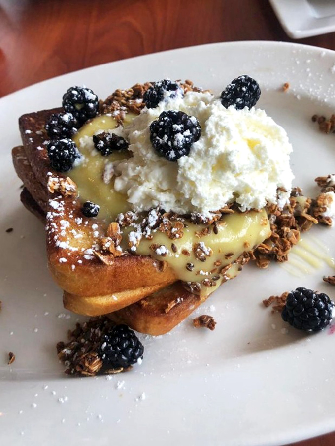 Not just French toast—it's an architectural masterpiece of berries, cream, and golden bread that makes you question why you'd eat anything else.