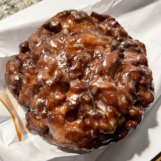 The holy grail of fried dough—glistening with glaze, pockmarked with caramelized apple pockets, and guaranteed to make you close your eyes in silent appreciation.