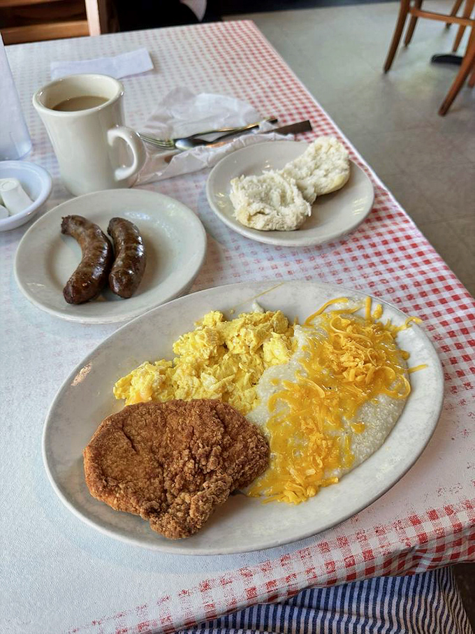 The holy trinity of Southern breakfast: a perfectly fried biscuit, creamy grits, and sausage links that snap when you bite them.