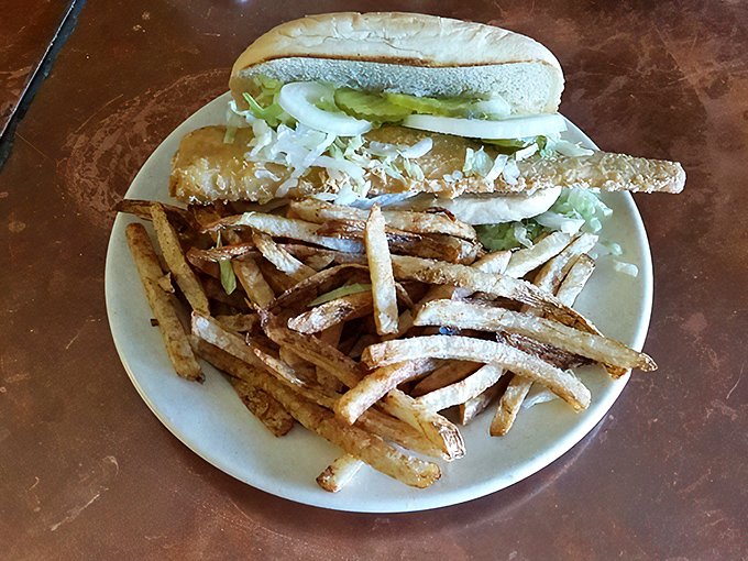 The fish sandwich arrives with green beans and fries. A balanced meal if you count looking at the vegetables as consuming them.