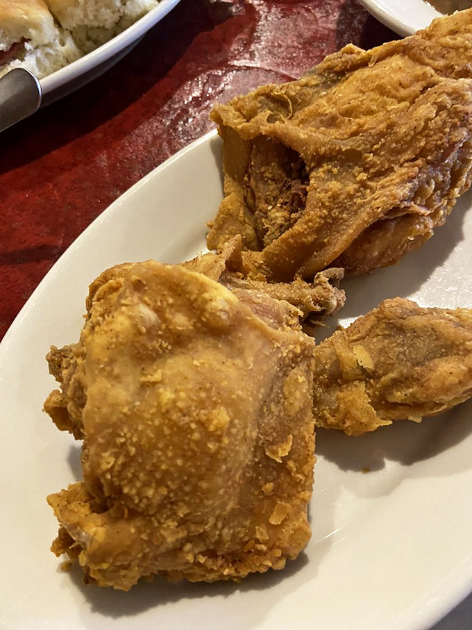 Each piece of chicken wears its golden crust like a medal of honor, earned through generations of culinary wisdom.