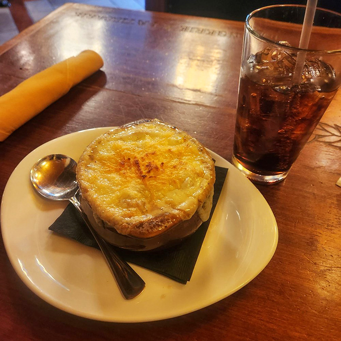 The broiled cheese forms a perfect seal over the soup, creating a delicious tension that begs to be broken with your spoon. 