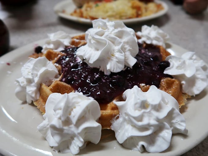 The Belgian waffle doesn't just wear its blueberry topping&mdash;it flaunts it with whipped cream islands that melt into sweet, happy puddles.