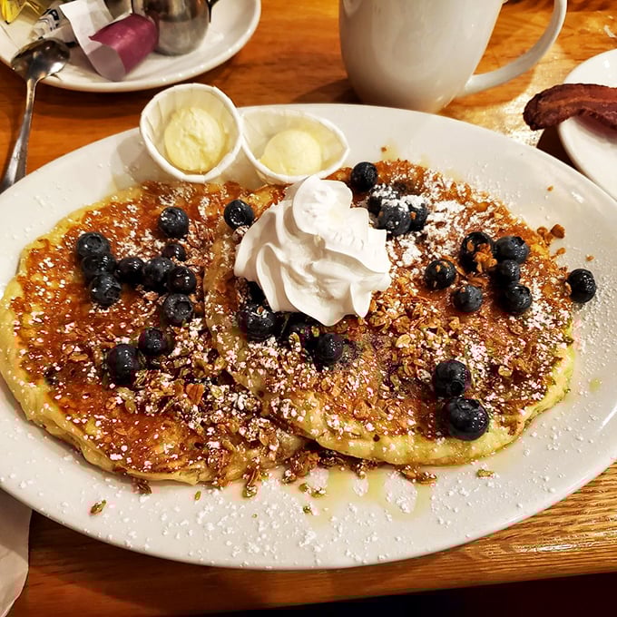These blueberry pancakes aren't just a breakfast&mdash;they're an event, complete with their own whipped cream snowcap and berry confetti.