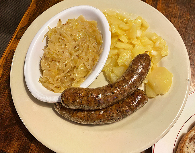 Two plump bratwursts, sauerkraut with attitude, and German potato salad&mdash;a trio so traditional yet satisfying, it's like comfort food got dressed up for a night out.