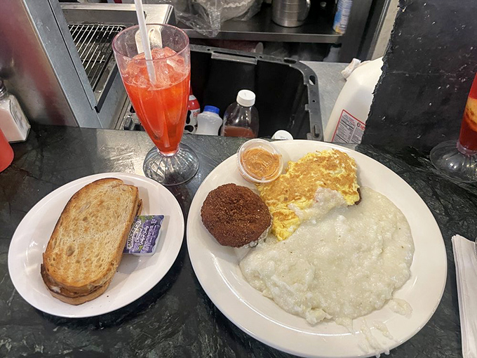 The breakfast holy trinity&mdash;eggs, pancakes, and bacon&mdash;performing their morning miracle on a plate that says, "Go ahead, cancel your lunch plans."