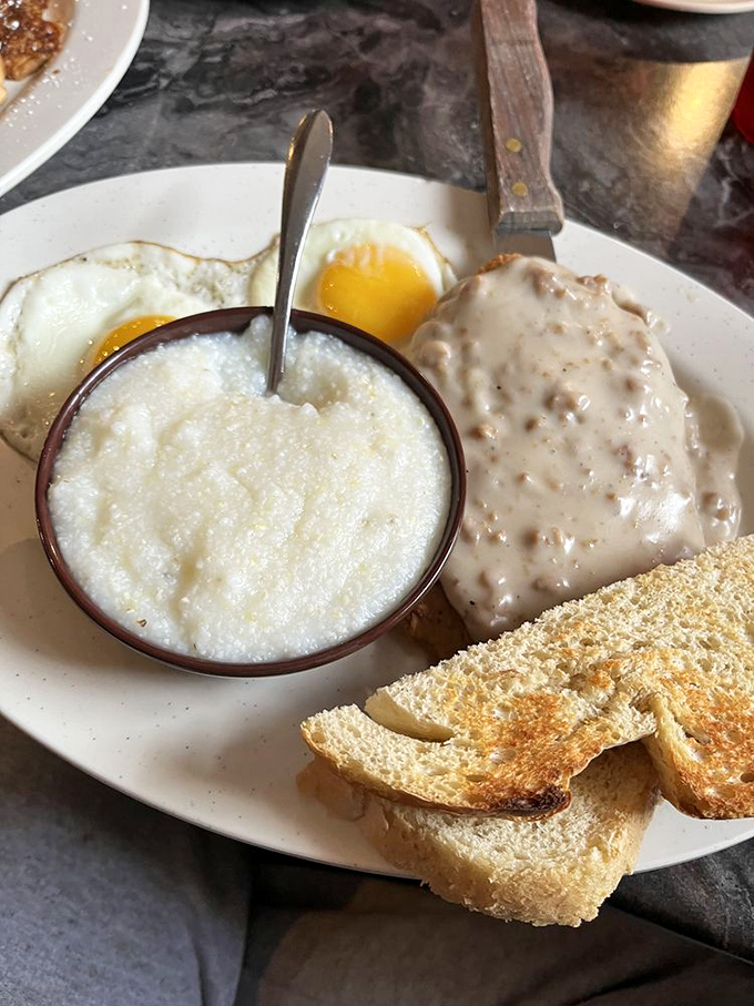 Grits and gravy sharing a plate like old friends at a reunion. Some relationships are just meant to be.