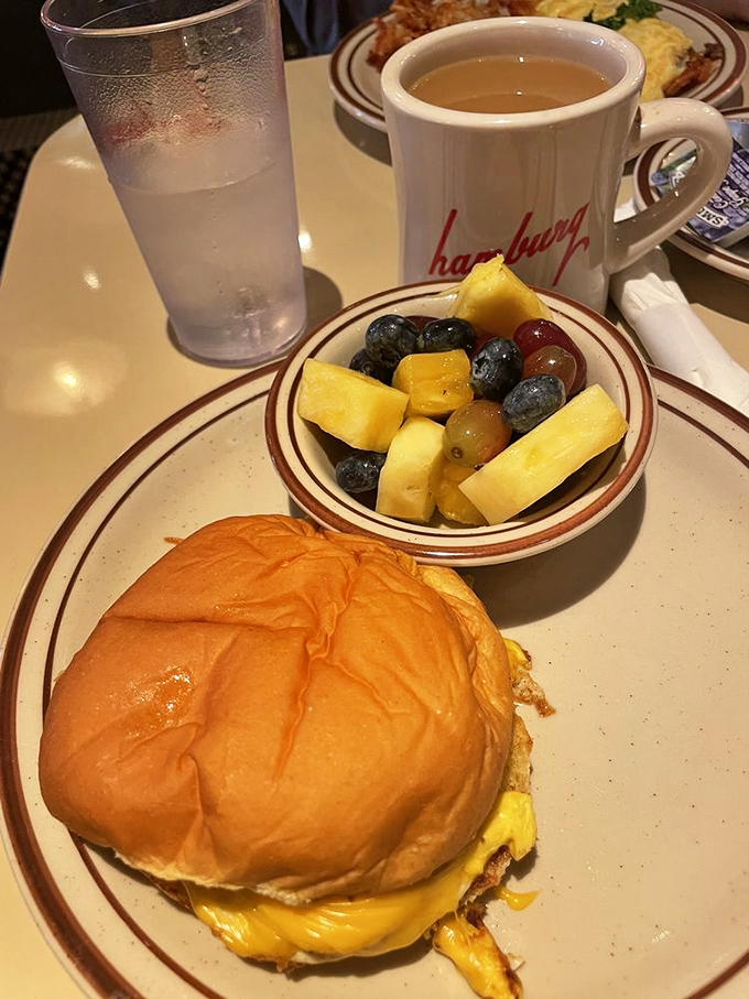 Eggs, hash browns, and fresh fruit&mdash;the holy trinity of breakfast done right. That coffee mug isn't just a vessel; it's a chalice of morning salvation.
