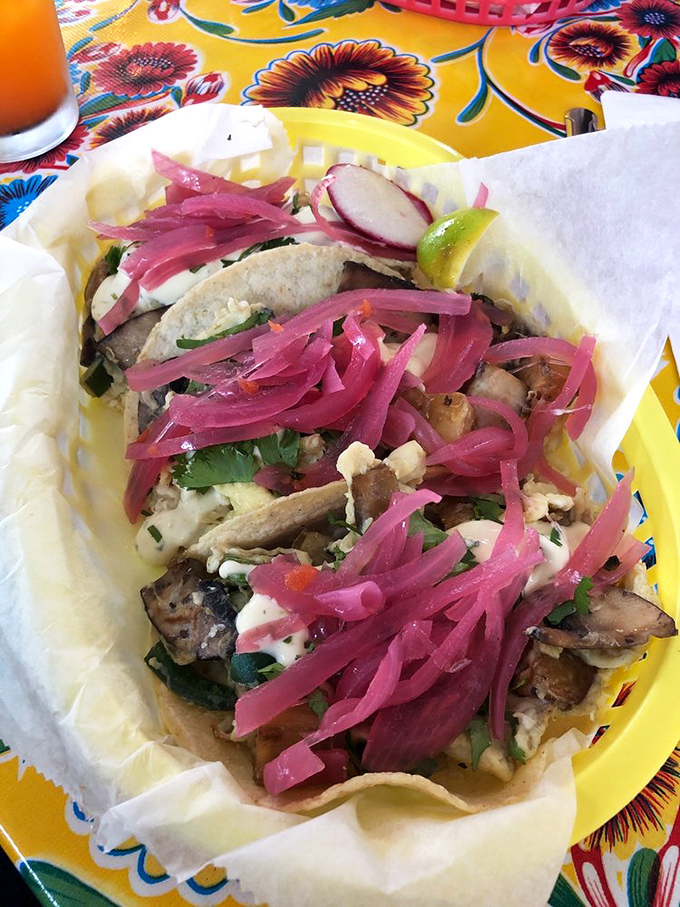 Breakfast tacos that make morning people out of night owls. That pink pickled onion adds the perfect tangy counterpoint to savory fillings.