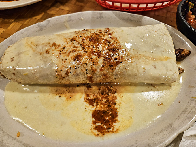 This burrito, wrapped in a warm embrace of cheese sauce, is what comfort food dreams are made of. Napkins required, regrets forbidden. 