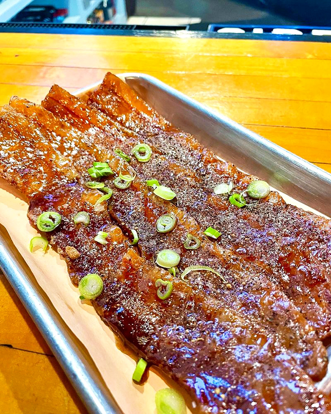 Ribs with that glistening, caramelized exterior and green onion garnish. The kind that make you forget napkins exist until it's too late.