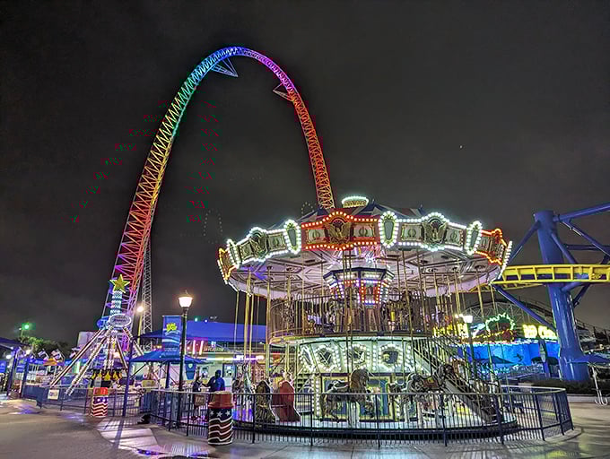 The carousel glows with vintage charm after dark, a neon-illuminated time machine that's been creating multi-generational memories for decades.