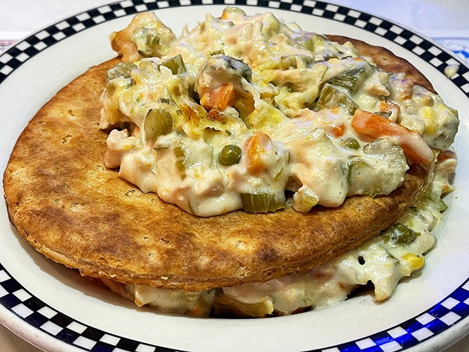 Not your cafeteria lady's pot pie! This golden-crusted beauty erupts with creamy vegetable filling, proving that comfort food can also be photogenic.