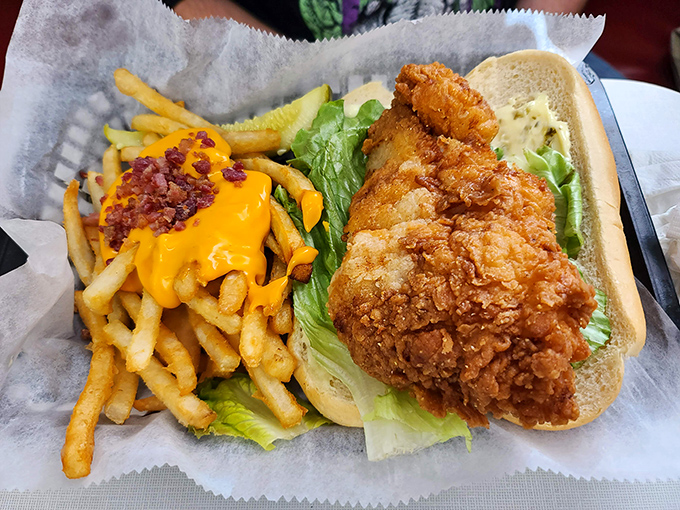 A chicken sandwich that refuses to be contained by mere bread boundaries, with cheese fries that deserve their own fan club.