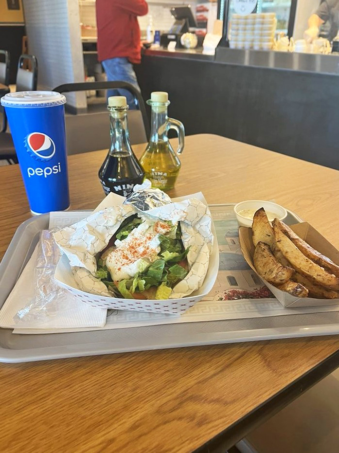 This isn't just lunch&mdash;it's edible architecture. Crispy potato wedges stand guard beside a chicken gyro that's practically begging to be photographed before eaten.