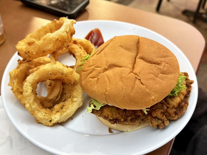 A fried chicken sandwich with onion rings that would make even the most dedicated health enthusiast whisper, "Worth it." That golden batter deserves a trophy.