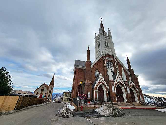 St. Mary in the Mountains Catholic Church stands majestically against dramatic skies, its brick and white spire a spiritual beacon since mining boom days.