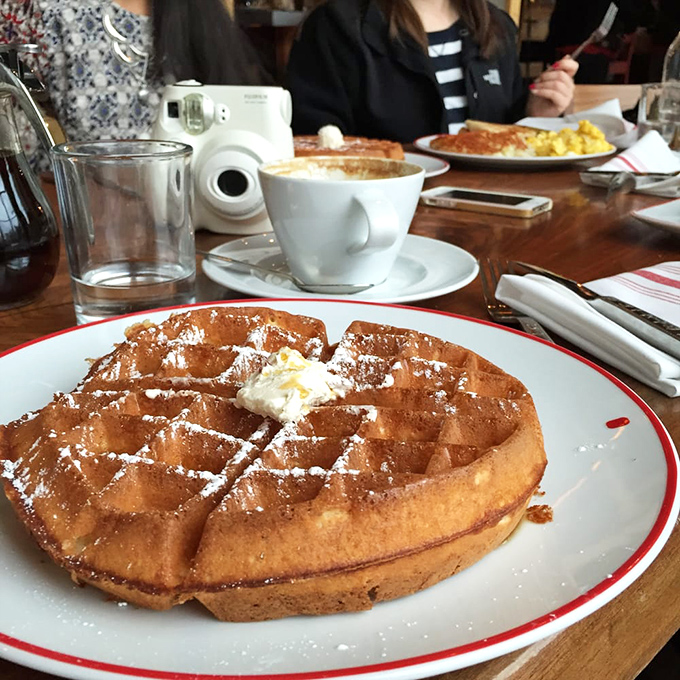 A waffle that deserves its own Instagram account. Golden, crispy exterior giving way to a fluffy interior, with a dollop of butter slowly melting into those perfect squares.