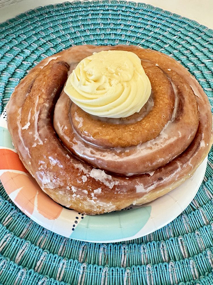 This isn't just a cinnamon roll; it's a spiral-shaped love letter topped with cream cheese frosting that whispers sweet nothings to your taste buds.
