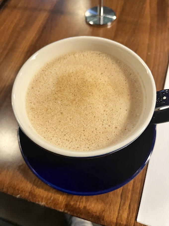 This isn't just coffee&mdash;it's a blue-hued revelation sitting on wood that's seen more fascinating conversations than most therapists.