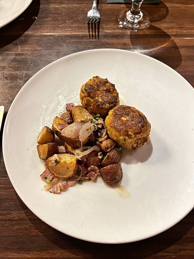 What looks like humble crab cakes are actually Delaware's answer to culinary royalty &ndash; golden-crusted treasures atop roasted potatoes that didn't come to play.