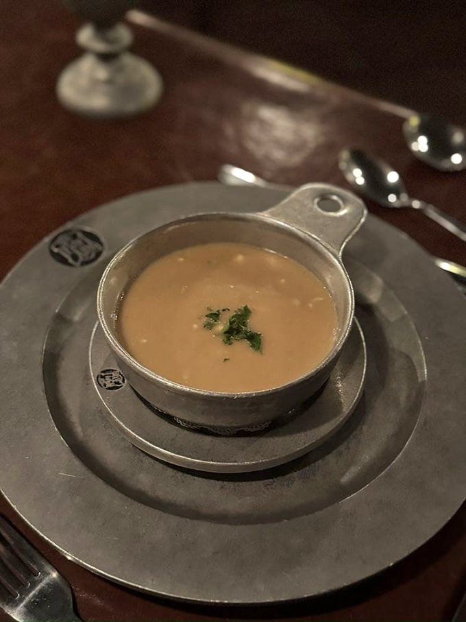 The soup arrives in its own tiny cauldron, as if a very tidy witch decided to focus her talents on comfort food instead of spells.
