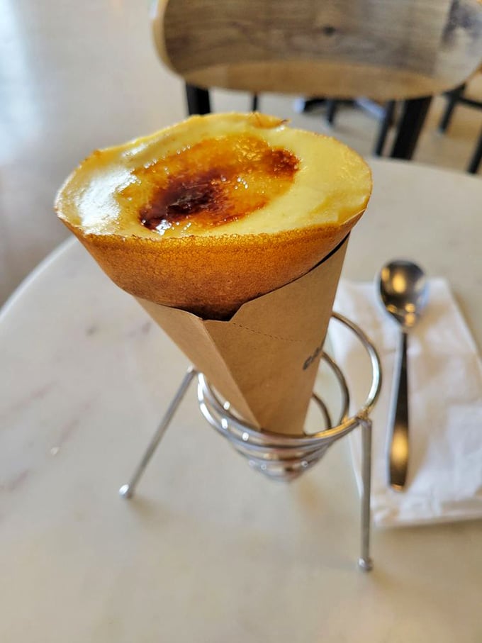 The cr&egrave;me br&ucirc;l&eacute;e crepe comes dressed for success&mdash;a paper cone cradles custard perfection with that signature caramelized top.