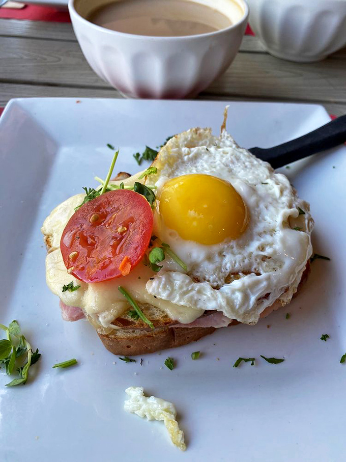 The Croque Madame stares back with its sunny-side eye, daring you not to fall in love with its melty cheese embrace and perfect egg hat.
